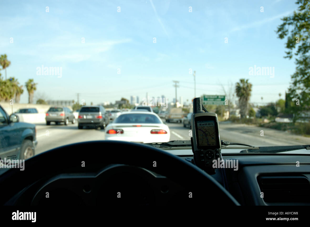 GPS unit mounted on vehicle's dashboard. Driving on freeway Stock Photo ...