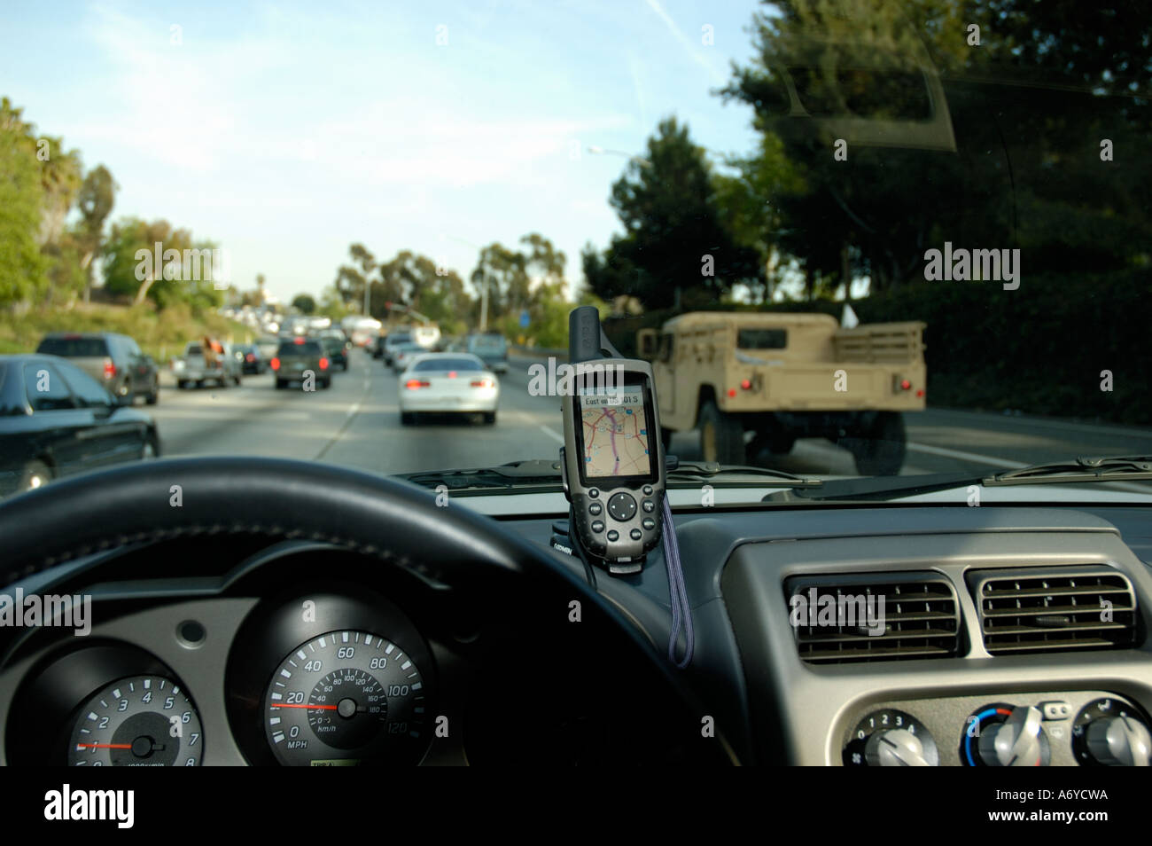 GPS unit mounted on vehicle's dashboard. Driving on freeway Stock Photo ...
