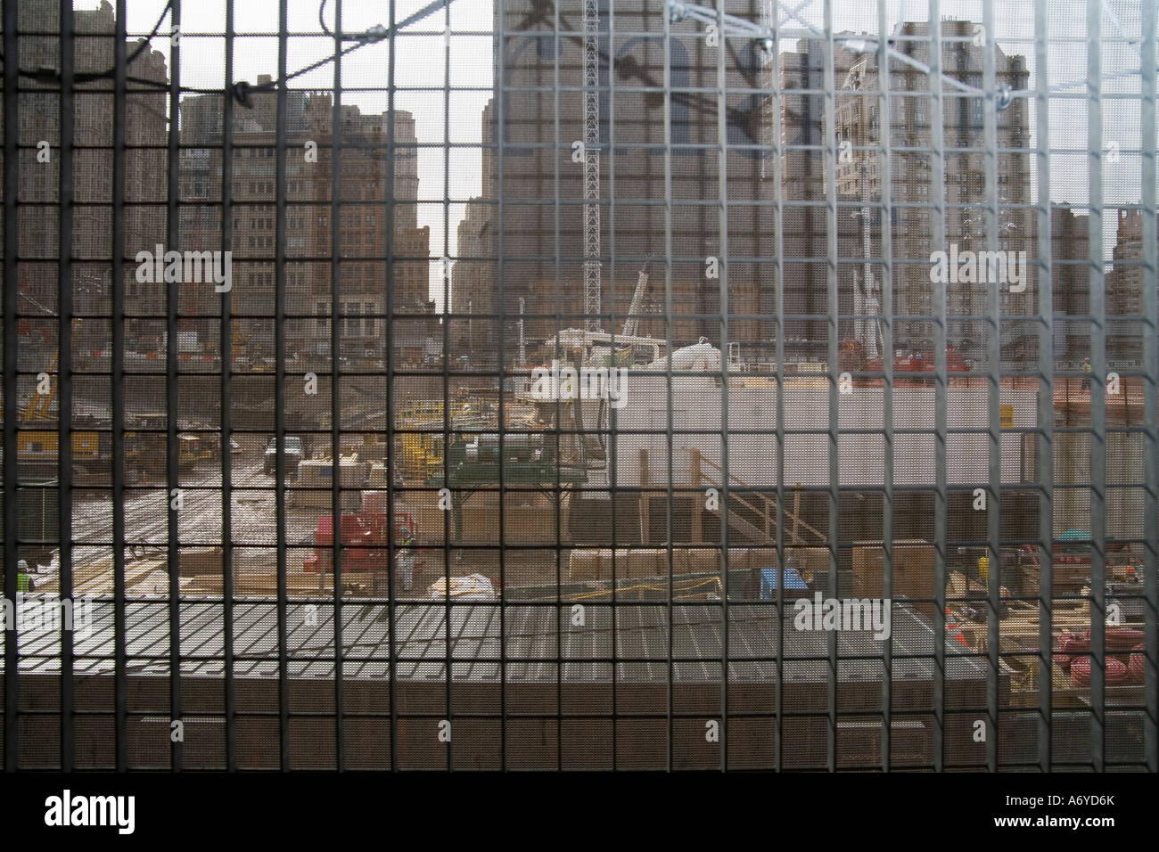 View through metal grid of construction site Stock Photo - Alamy