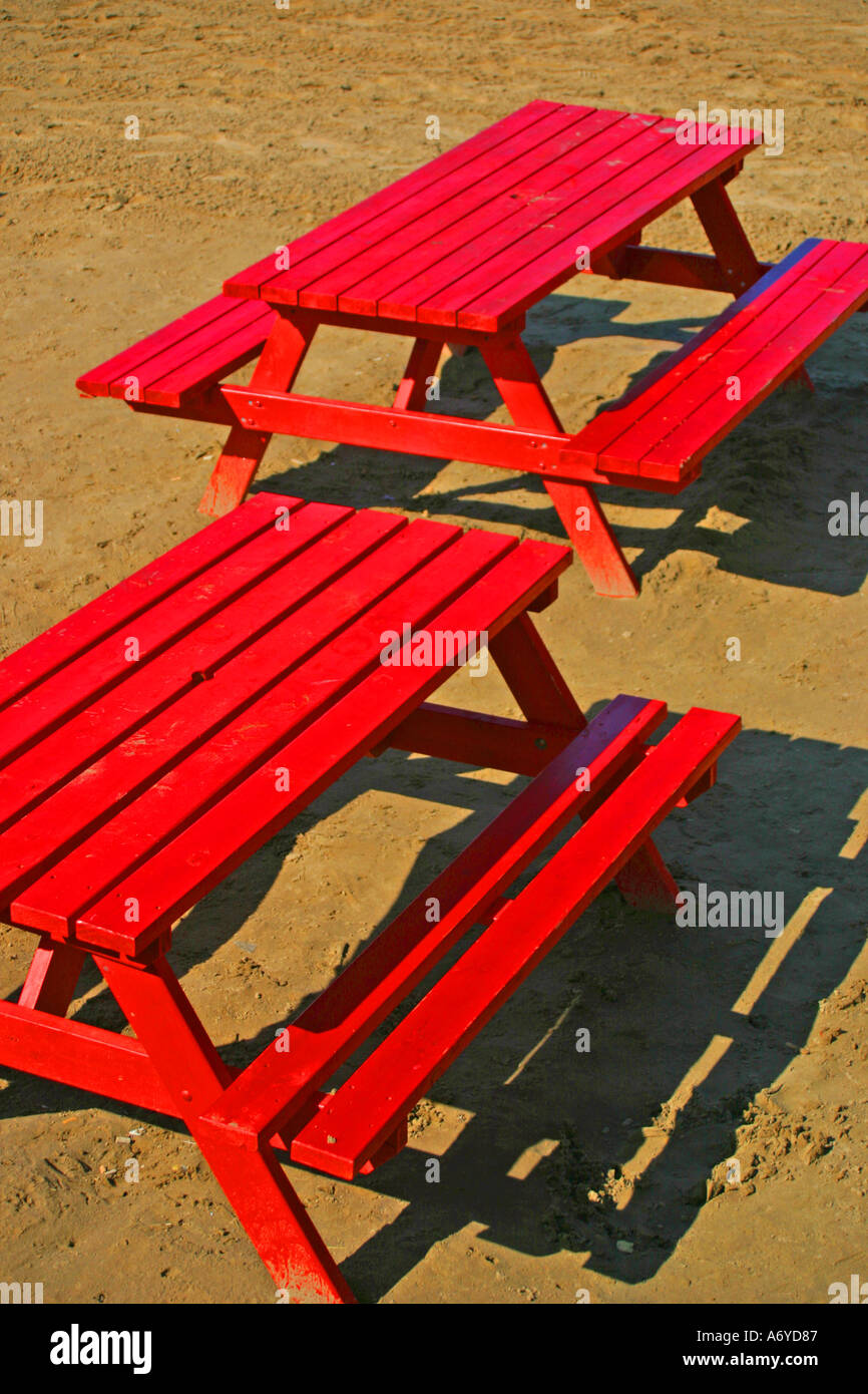 red picnic benches on a beach Stock Photo - Alamy