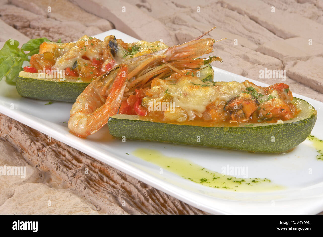Courgettes stuffed with prawns and fish with basil Stock Photo - Alamy