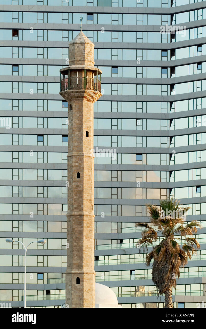 Minaret of a mosque in front of modern office block Stock Photo - Alamy