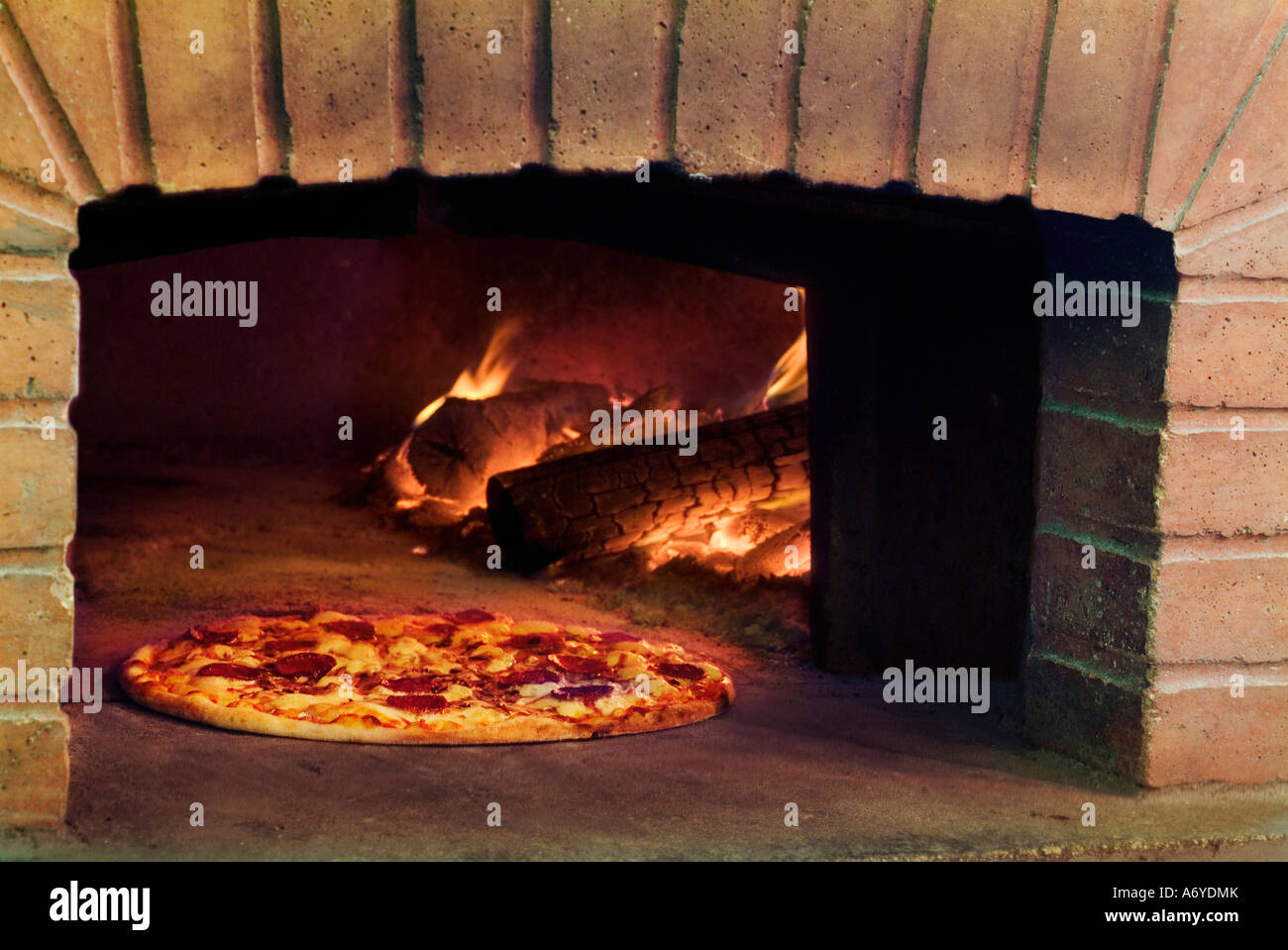 Pizza cooking in stone oven Stock Photo - Alamy