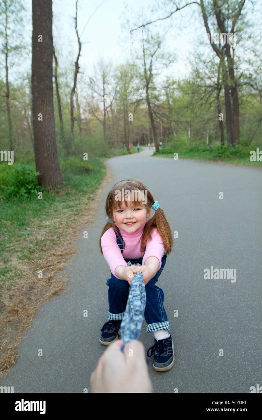 Young girl pulling on cloth Stock Photo - Alamy