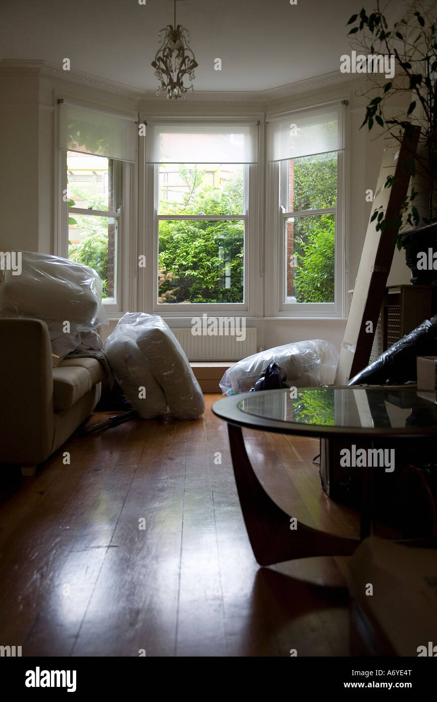 Messy living room whilst moving house Stock Photo - Alamy
