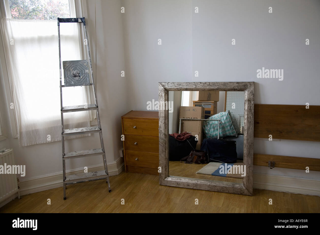 Furniture packed up in a room for moving house Stock Photo - Alamy