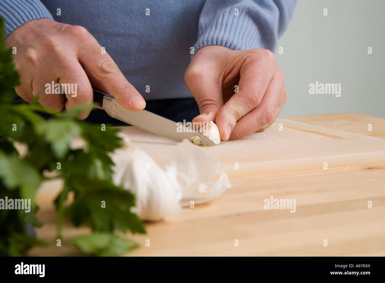 A man chopping garlic Stock Photo - Alamy