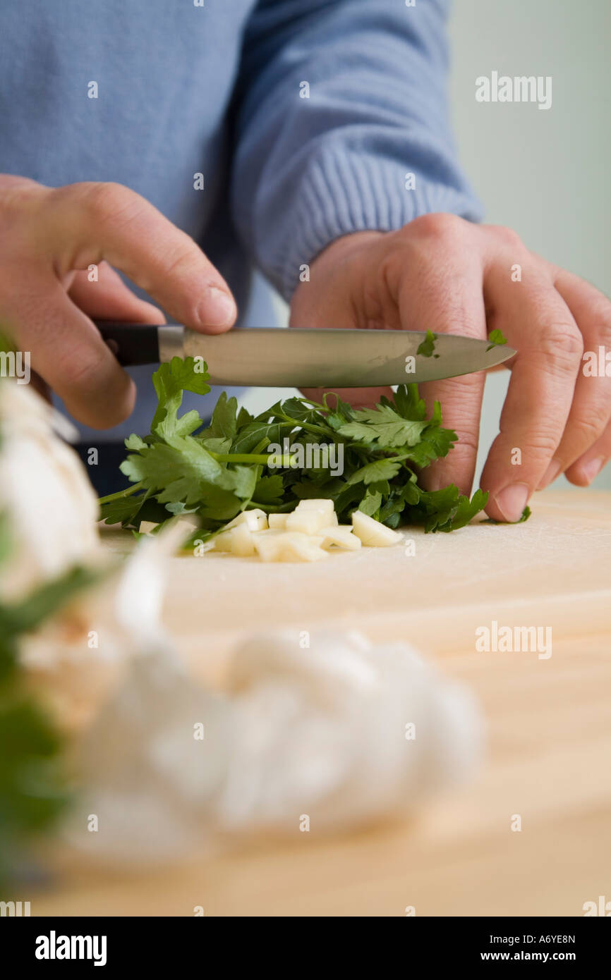 A man chopping flat leaf parsley Stock Photo - Alamy