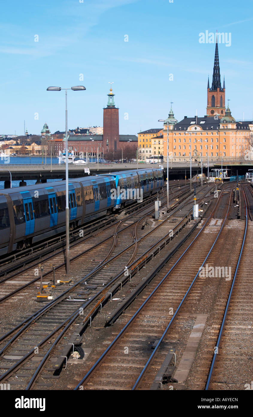 Blue train passing the bridge at Slussen with Riddarholmen and the ...