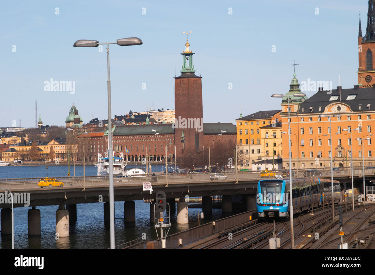 Blue train passing the bridge at Slussen with Riddarholmen and the ...
