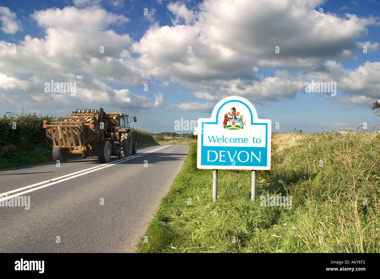 Welcome to Devon sign with road and tractor Devon England Stock Photo ...
