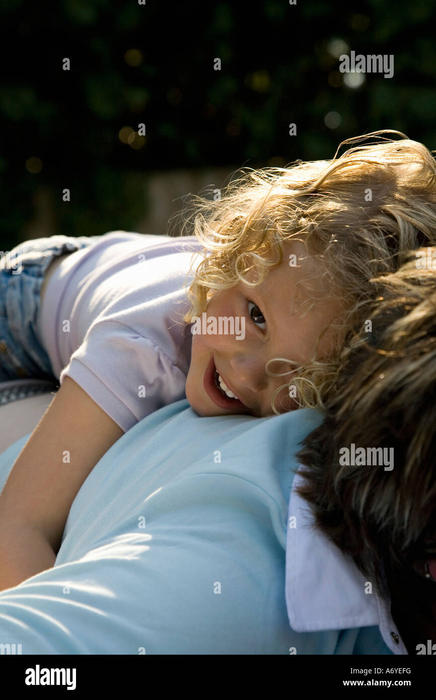Young girl with her arms around her mother Stock Photo - Alamy