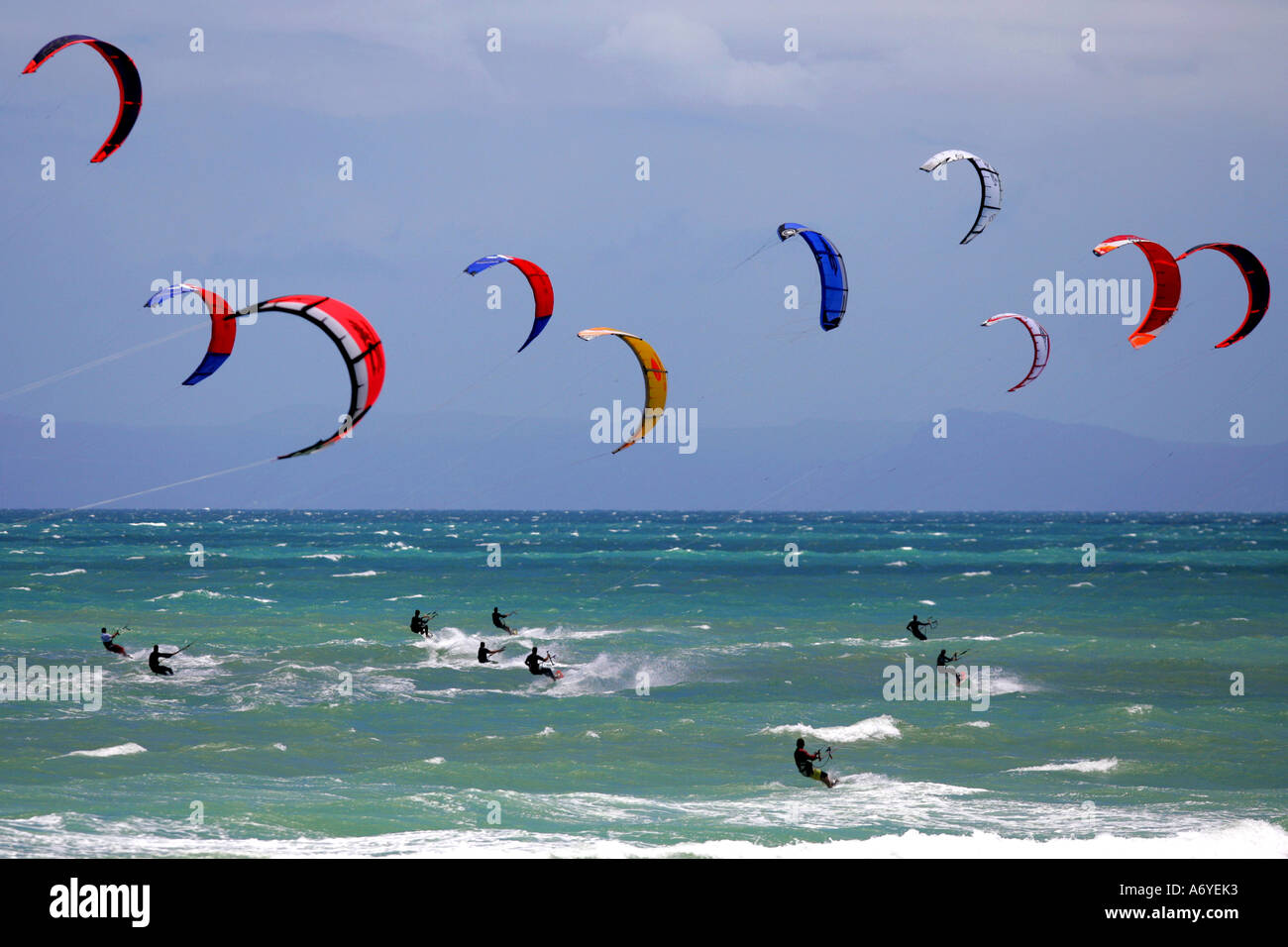Group of kiteboarders riding with windpower on the blue ocean Stock ...