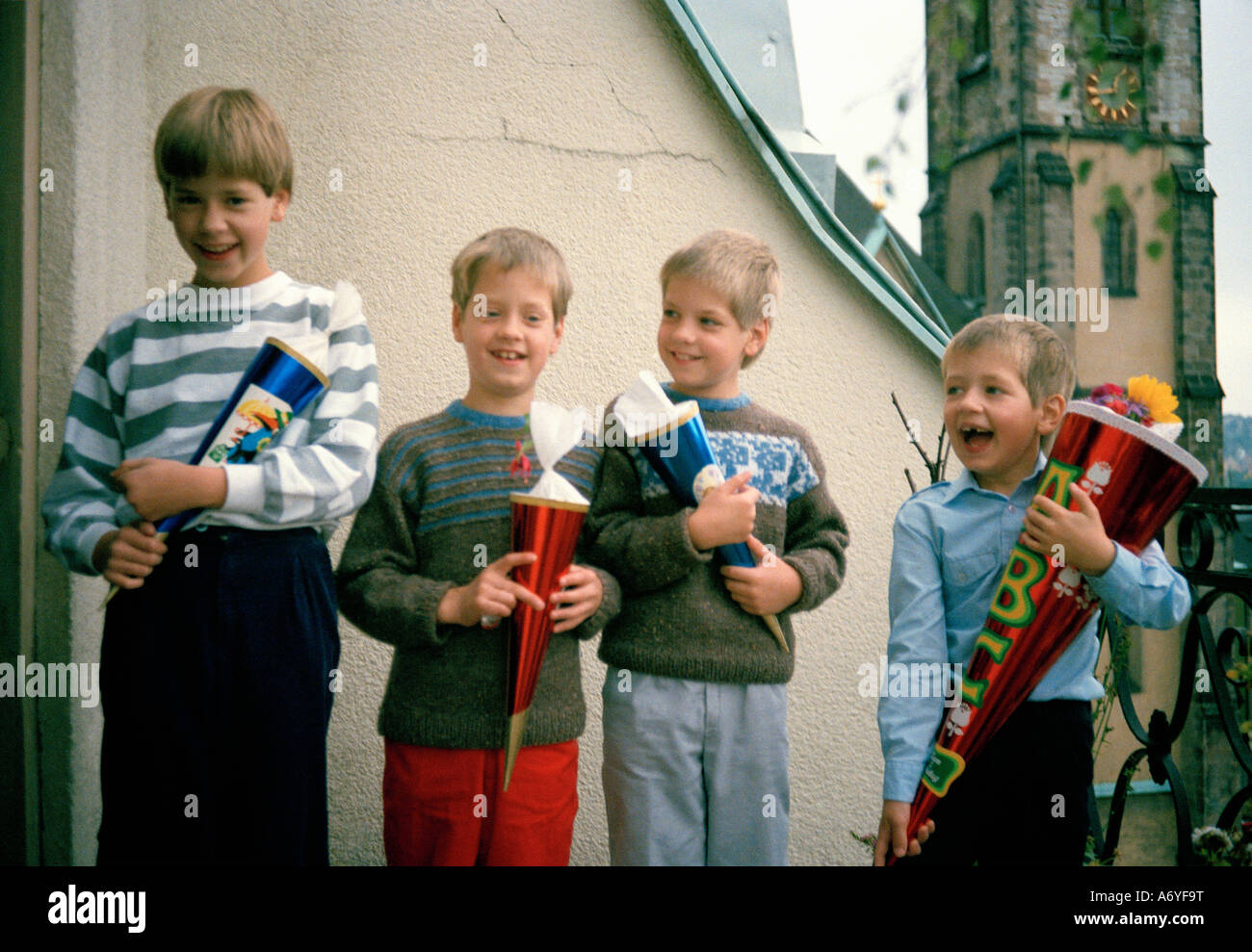 Four children standing in a row Stock Photo - Alamy