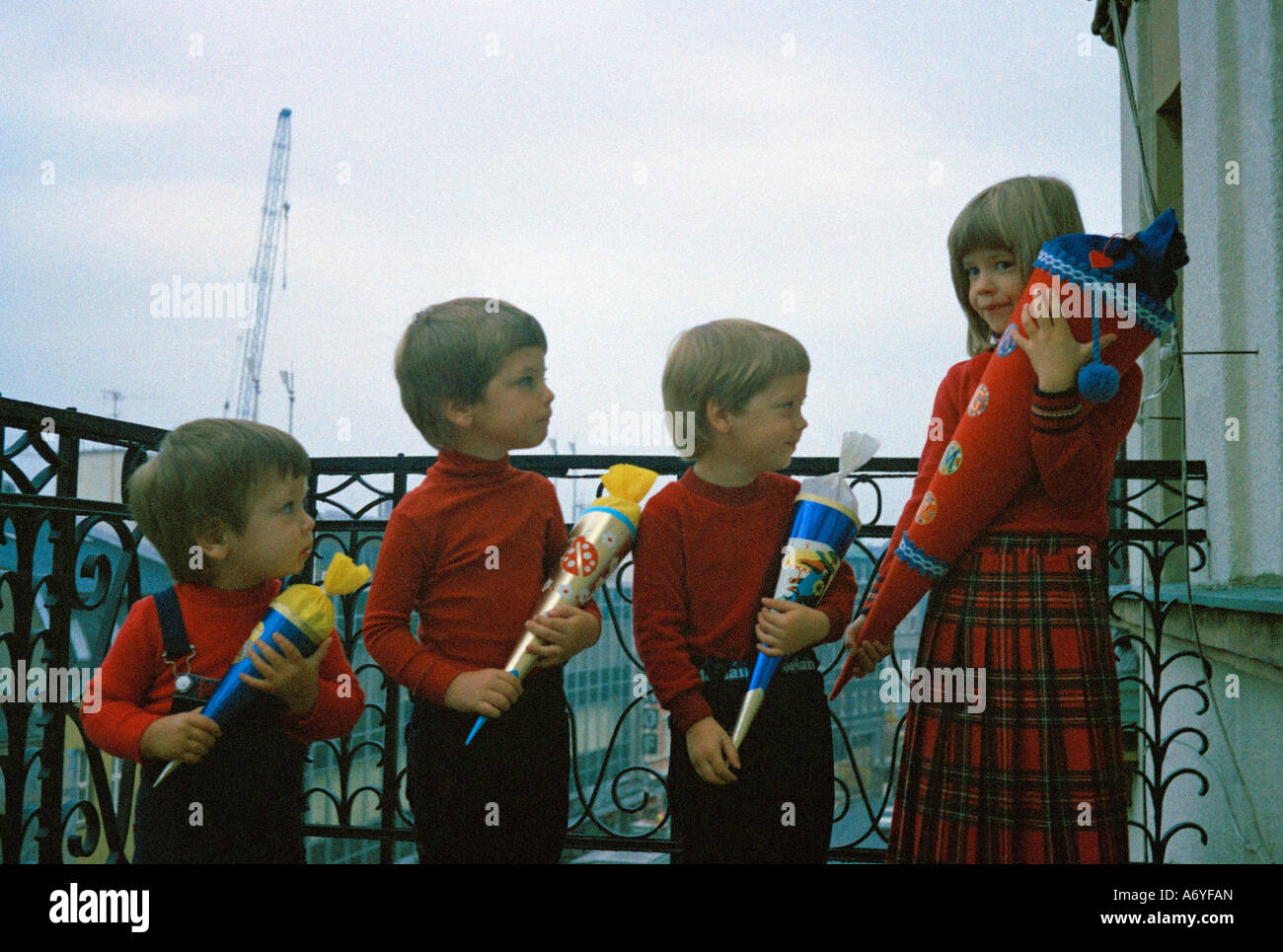 Four children standing in a row Stock Photo - Alamy