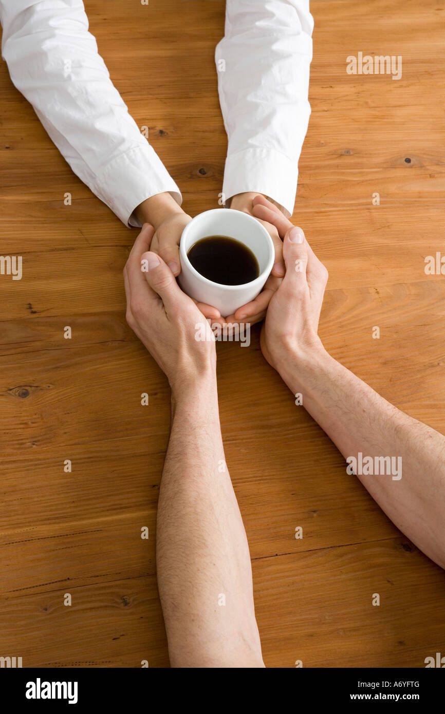 Holding hands across table hi-res stock photography and images - Alamy