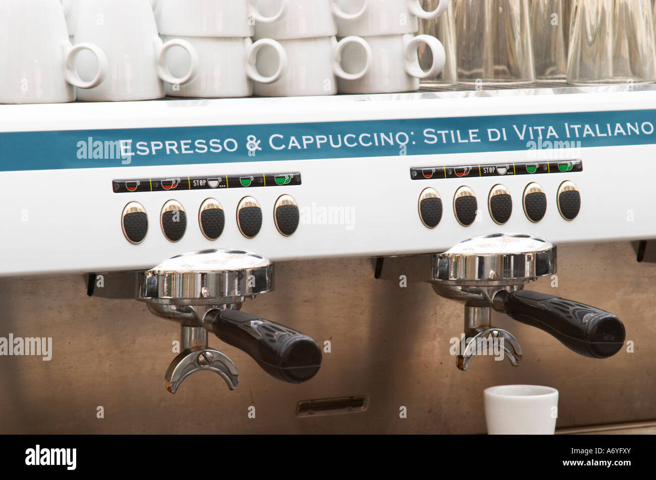 Espresso and Cappuccino machine, polished shining, with cups stacked on ...