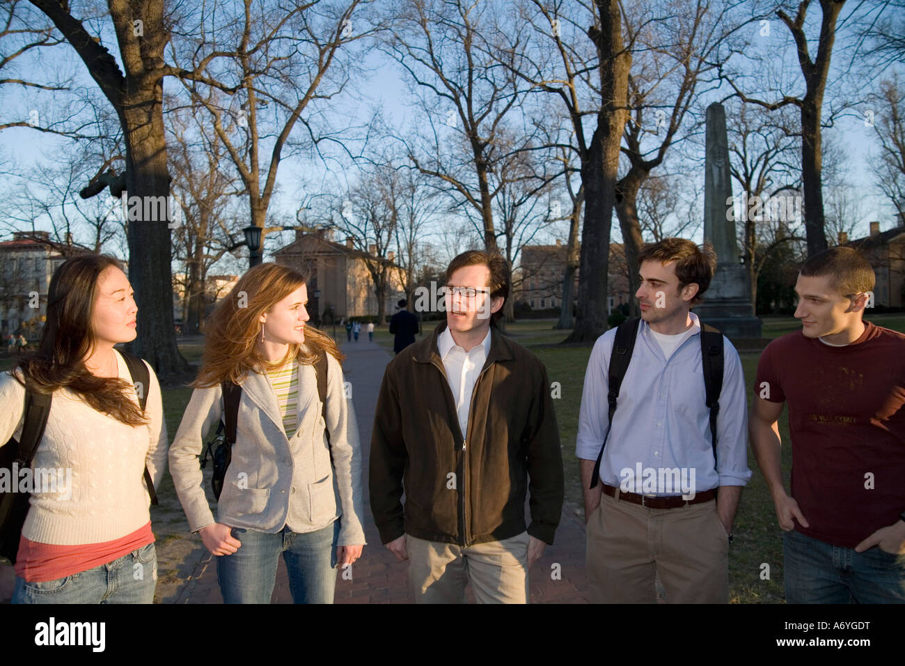 University students and lecturer walking outside Stock Photo - Alamy
