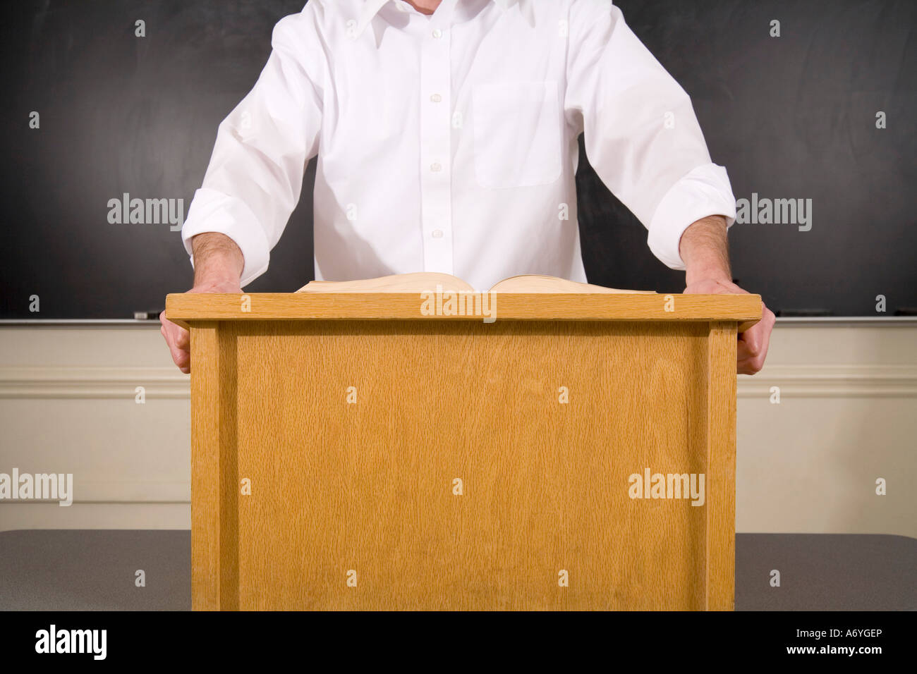 Lecturer standing behind lectern Stock Photo - Alamy