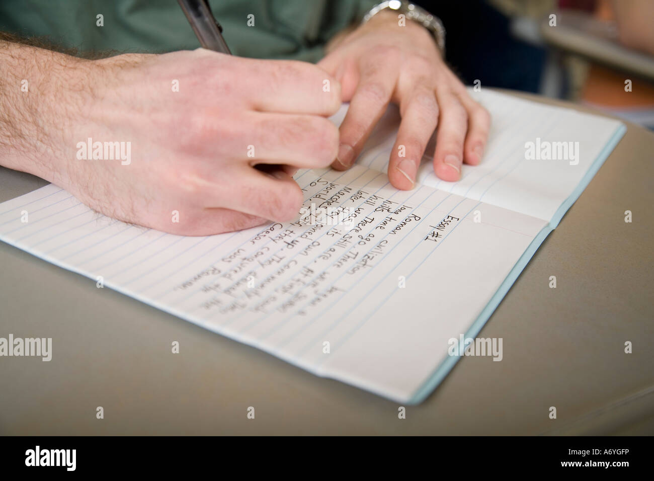 Person writing in notebook Stock Photo - Alamy