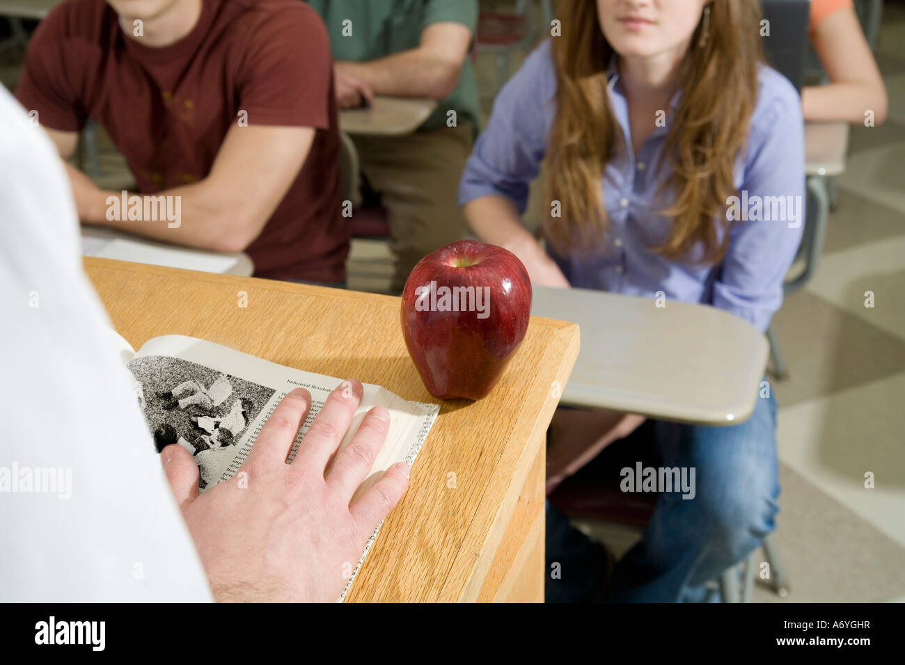 Lecturer standing at lectern with an apple Stock Photo - Alamy