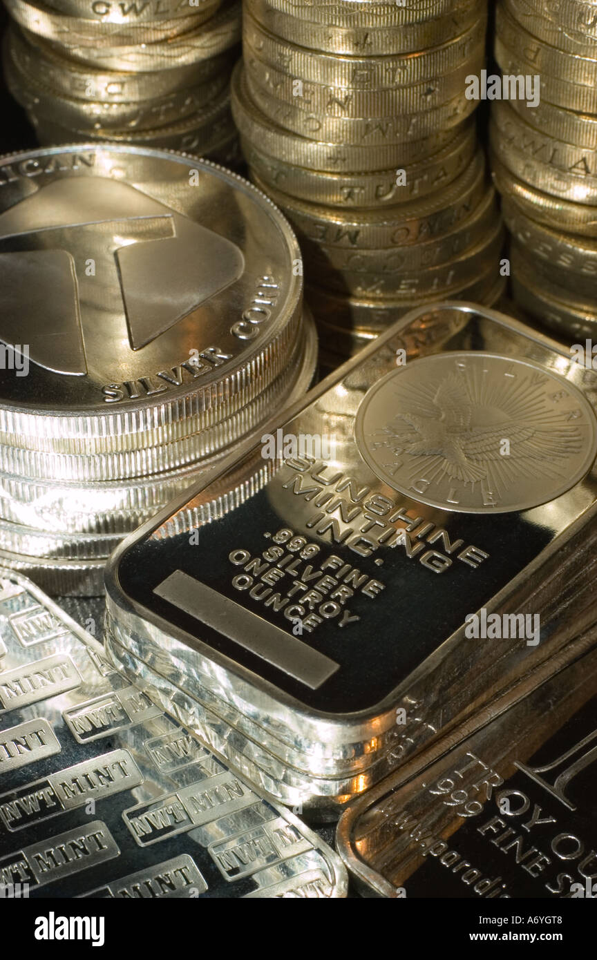 Silver Bullion in round and ingot forms with UK pound coins Stock Photo ...