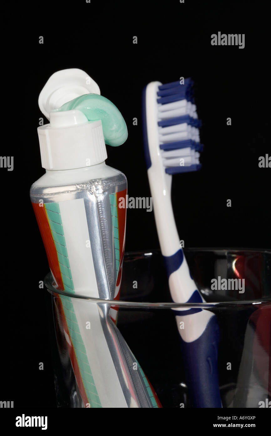 Toothpaste and toothbrush in a glass Stock Photo - Alamy