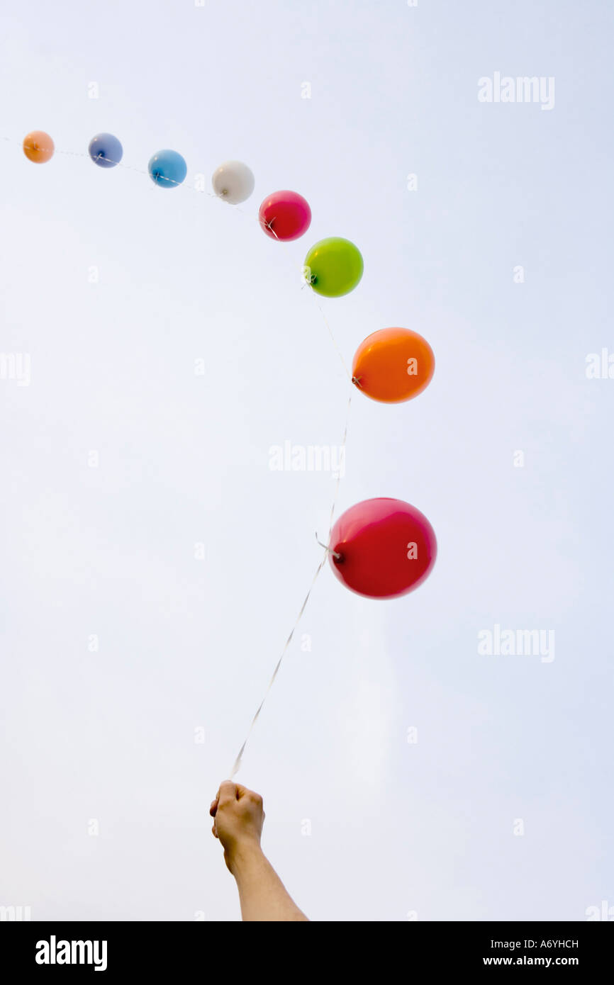 Helium balloons tied to a string Stock Photo - Alamy