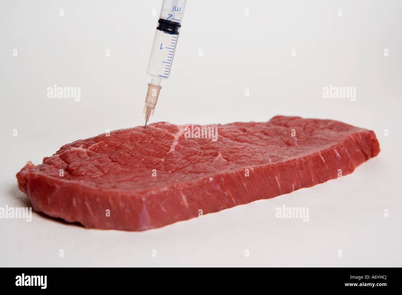 A syringe injecting meat Stock Photo - Alamy