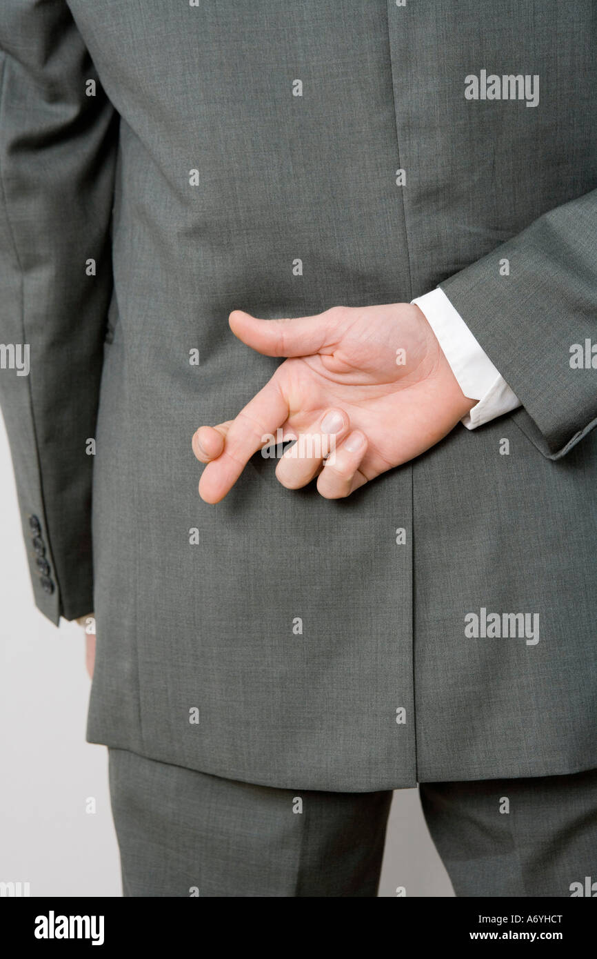 A man crossing his fingers behind his back Stock Photo - Alamy