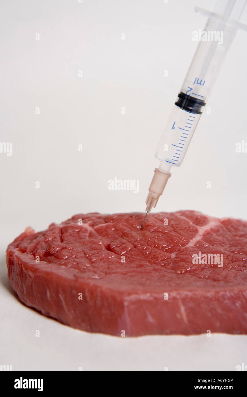 A syringe injecting meat Stock Photo - Alamy