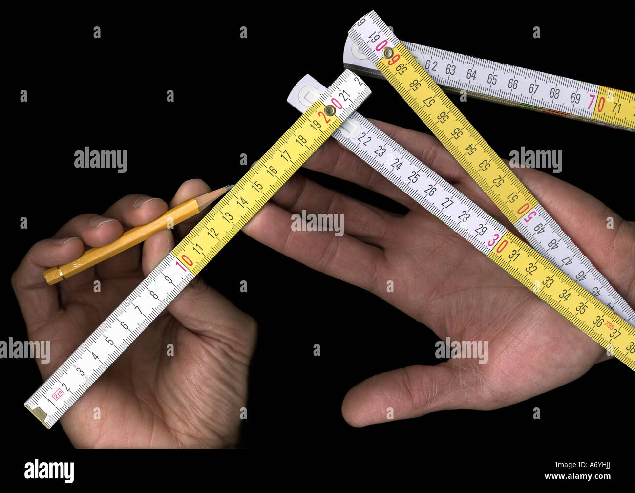 Man using a folding ruler and a pencil Stock Photo - Alamy