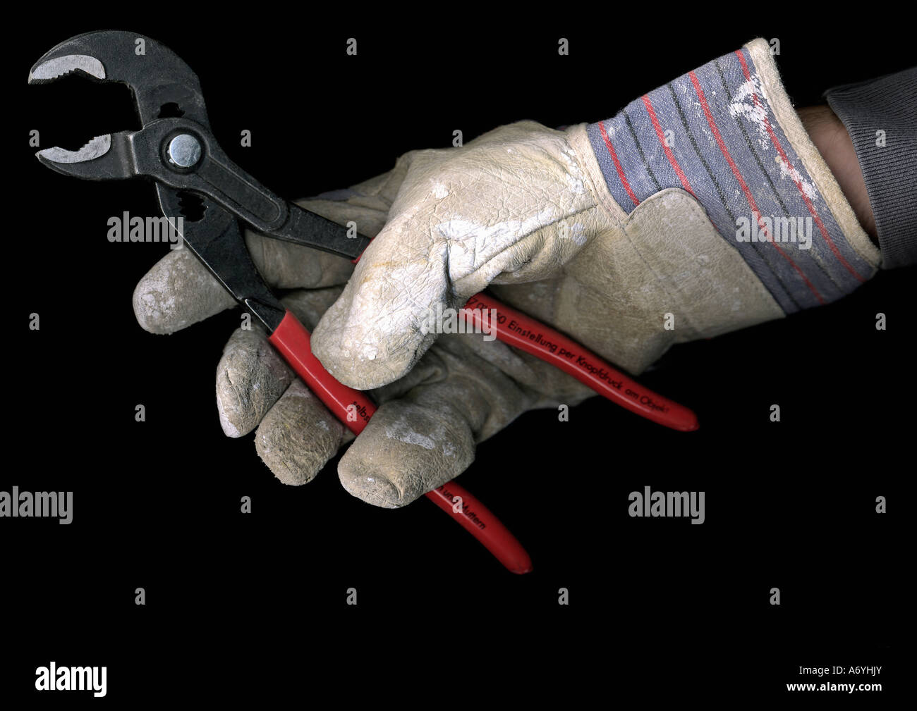 Man wearing a work glove and holding a pair of pliers Stock Photo - Alamy