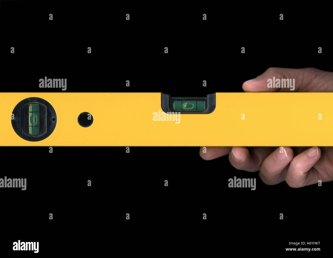 Man holding a spirit level Stock Photo - Alamy