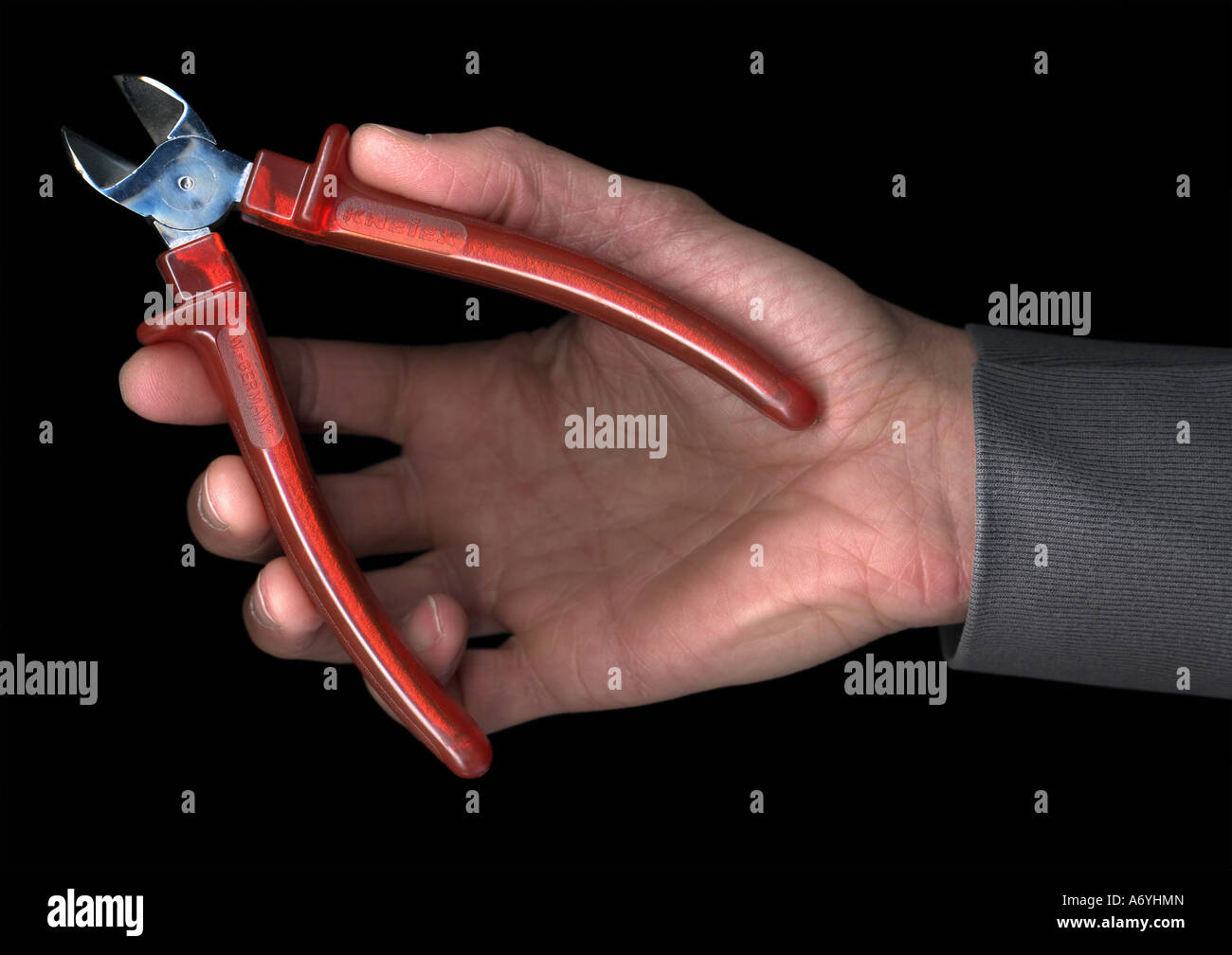 Man holding pliers Stock Photo - Alamy