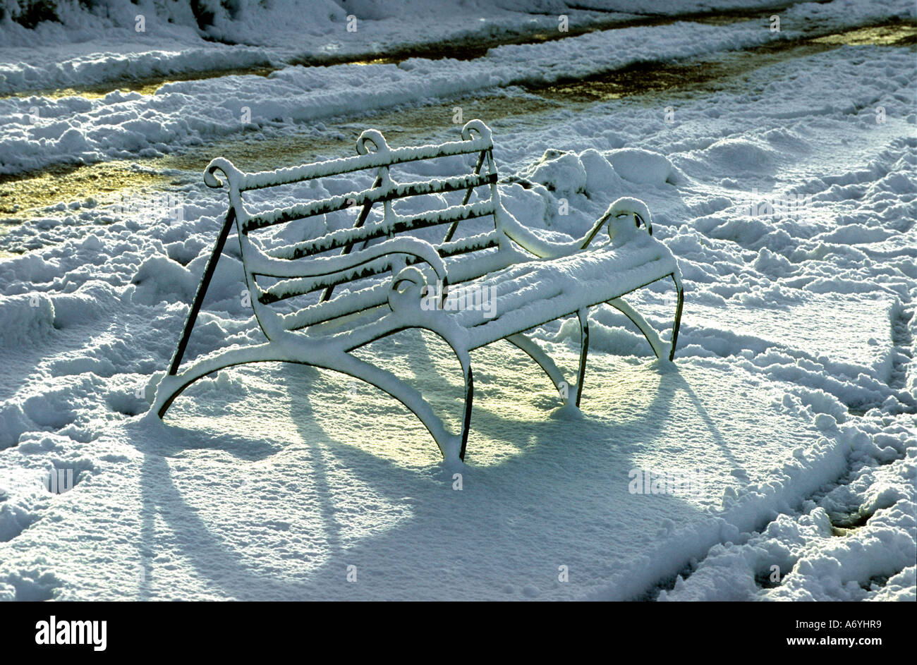 Snow covered bench seat by Derwent Water Stock Photo - Alamy