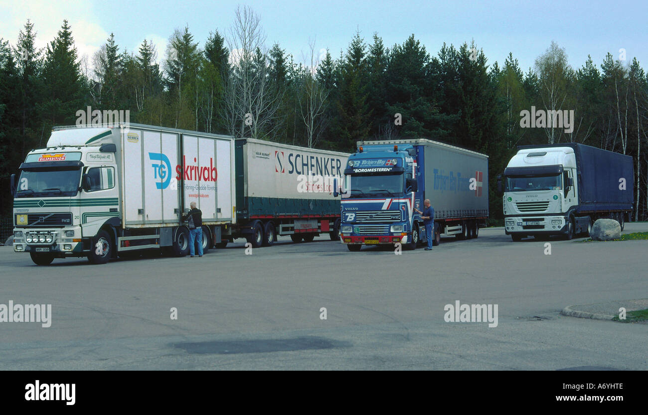 Three large trucks, lorries or long haulers parked at a rest stop south ...