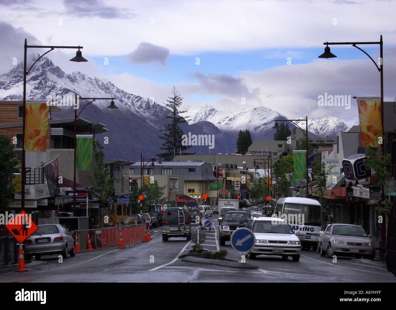 Queenstown main street with high snow capped mountains in background ...