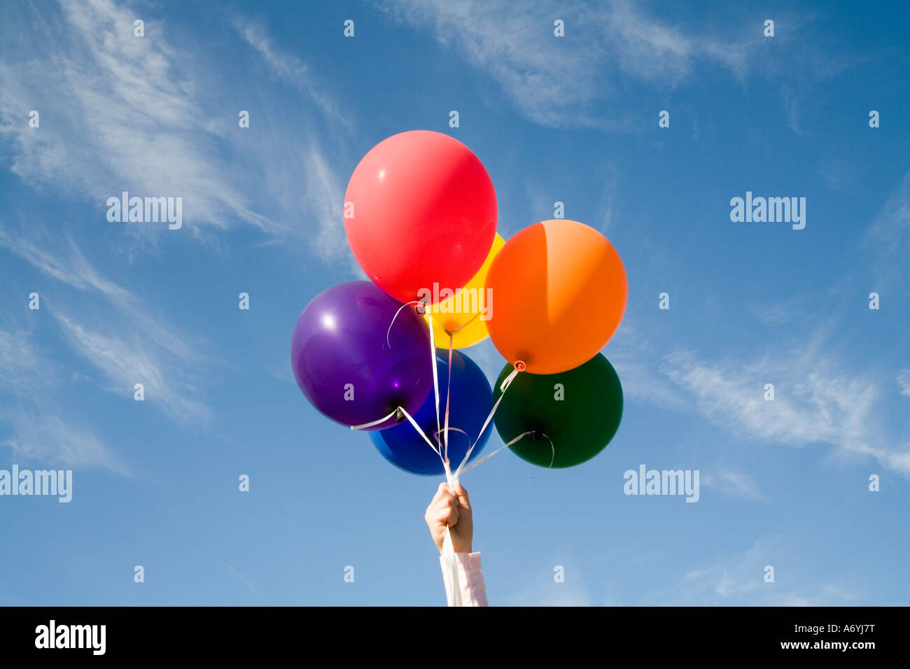 Hand holding helium balloons Stock Photo - Alamy