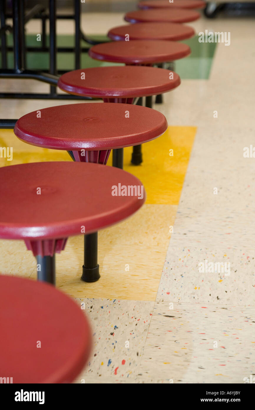 A row of stools in school canteen Stock Photo - Alamy