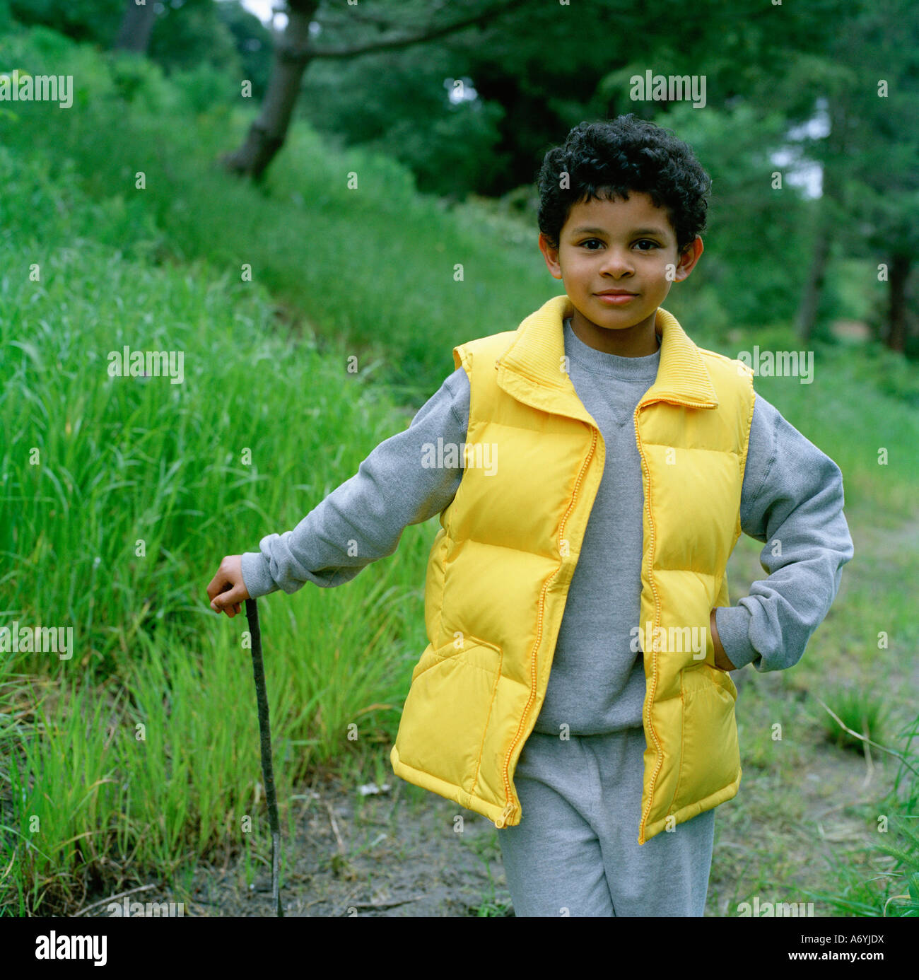 Boy posing with a walking stick Stock Photo - Alamy