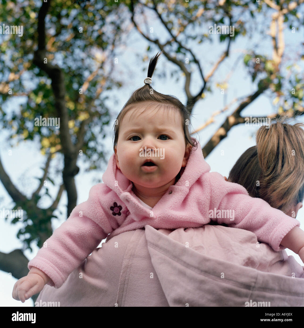 Mother carrying baby girl over her shoulder Stock Photo - Alamy Mother carrying baby girl over her shoulder Stock Photo - Alamy