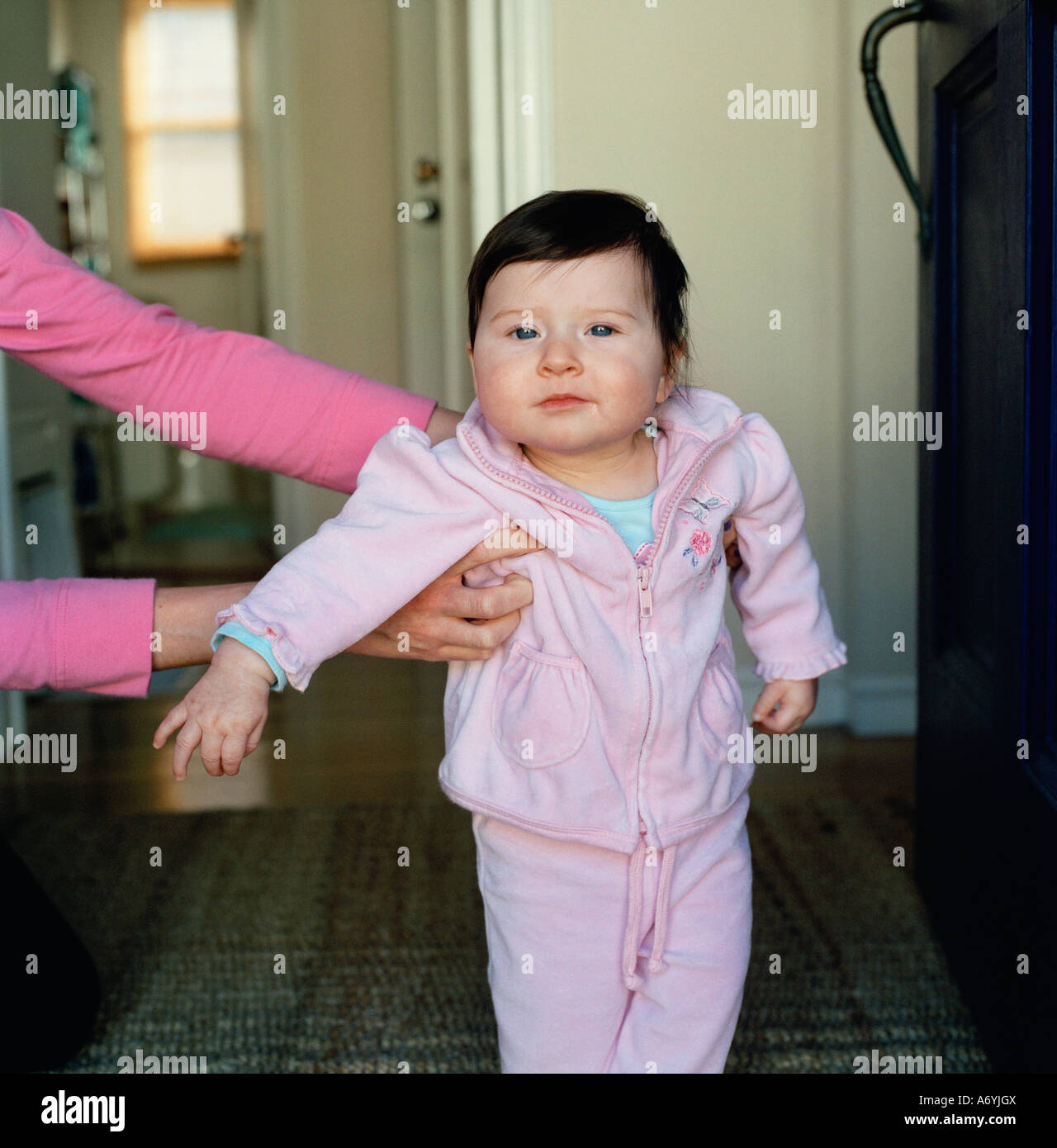 Mother teaching baby girl to walk Stock Photo - Alamy