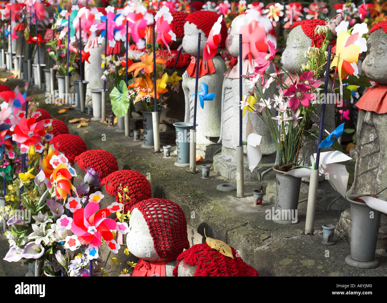 A colourful Japanese shrine with miniture windmills and decoration ...