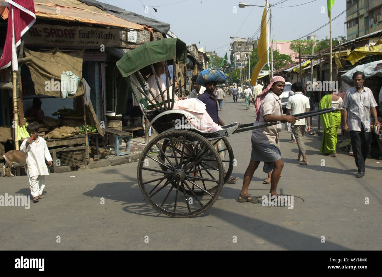 Rickshaw on the streets of Calcutta, India being pulled by a man ...