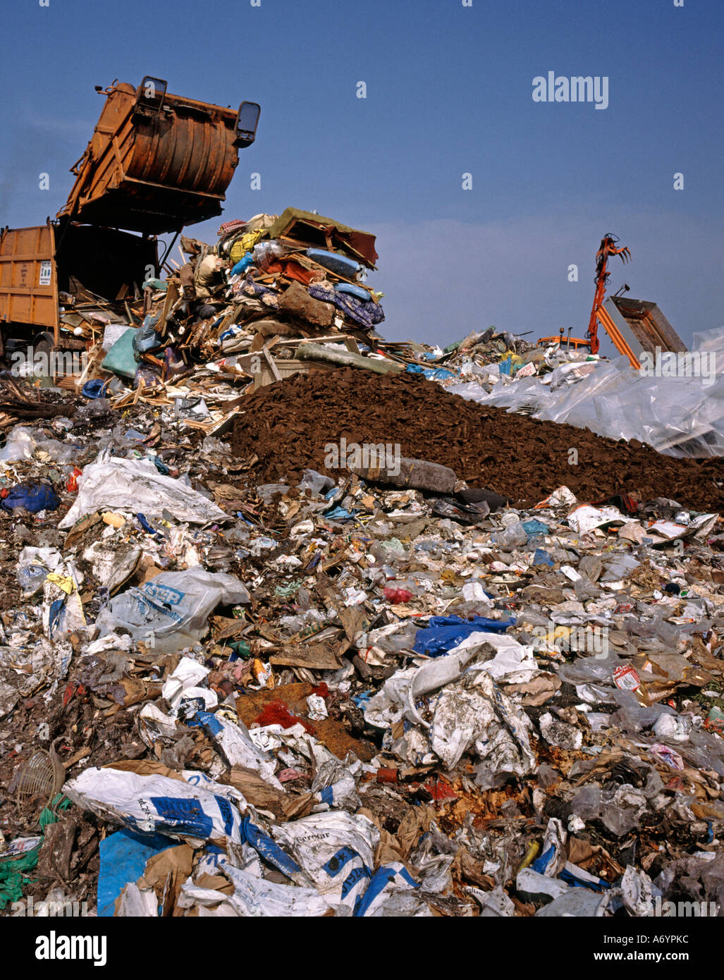 trucks emptying their loading of rubbish desposal trash garbage on ...
