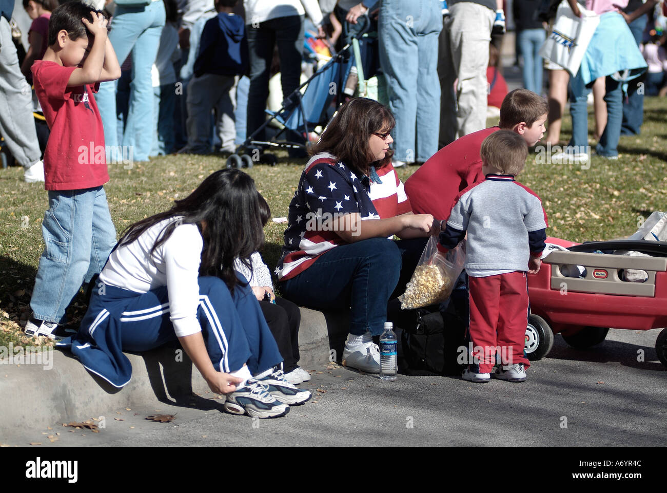 Mexican family sitting on the pavement Stock Photo - Alamy