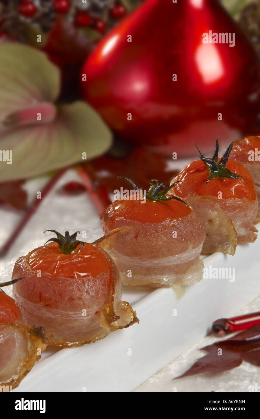 Baked cherry tree tomatoes wrapped up in bacon Stock Photo - Alamy