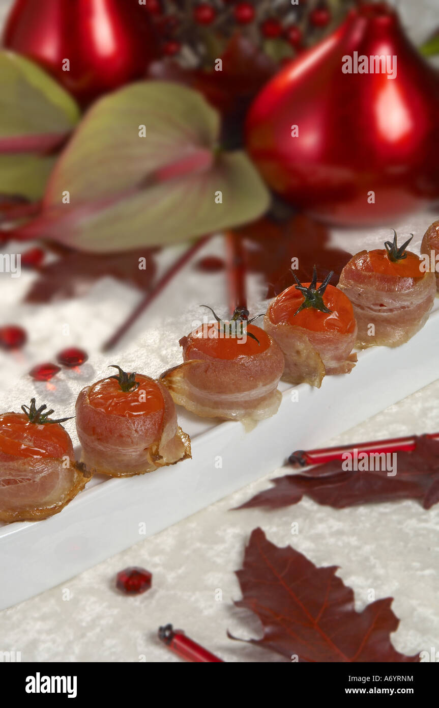 Baked cherry tree tomatoes wrapped up in bacon Stock Photo - Alamy