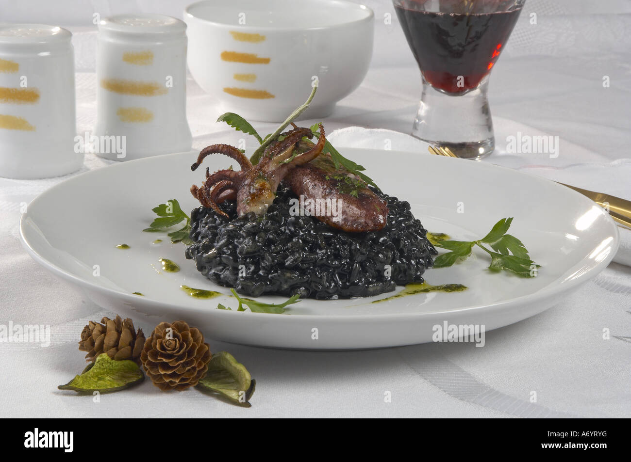 Black baby squid risotto Stock Photo - Alamy